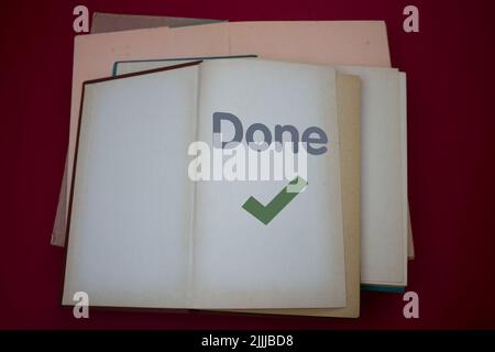 Done text with Checkmark in opened book with vintage, natural patterns ...