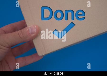 Done text with Checkmark with cardboard box. Brown folded cardbox Stock ...