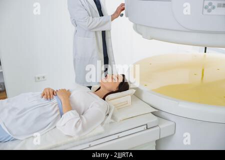Woman patient is ready to do magnetic resonance imaging MRI or CT scan ...