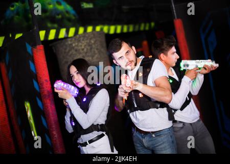 Young people playing laser tag Stock Photo - Alamy