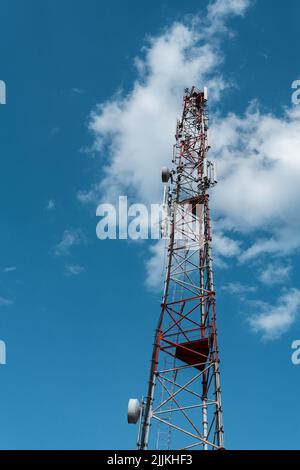 Hydro tower with blue cloudy sky as a backdrop Stock Photo - Alamy