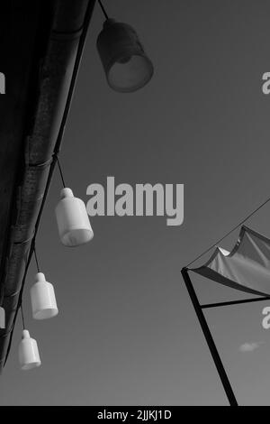 A grayscale low-angle shot of street lights lampposts Stock Photo - Alamy