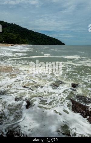 A beautiful shot of Rocks on the Seaside with rocky mountain in the ...