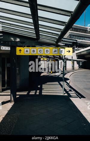 A signboard with symbols showing the direction of airport terminals ...