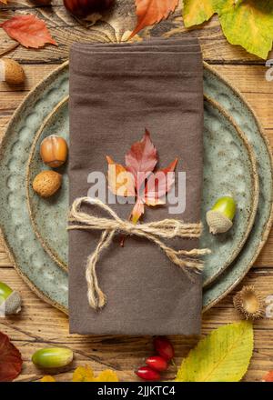 Autumn rustic table setting between leaves and berries on vintage ...