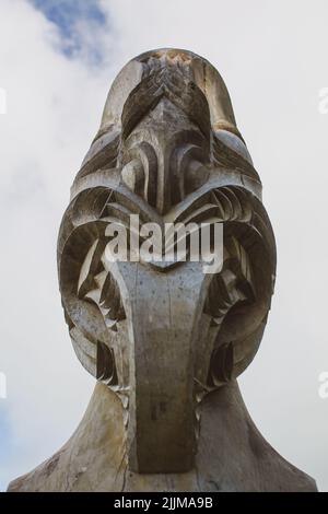 A vertical shot of the wooden Maori sculpture Stock Photo - Alamy