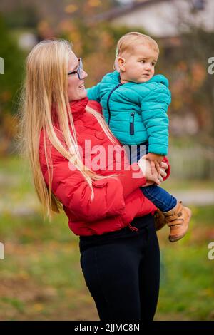 A vertical shallow focus shot of a red rose against a bokeh background ...