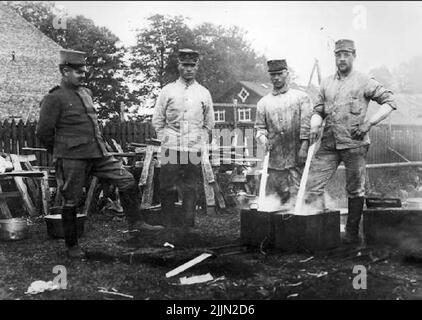 The engineering force, kitchen work in the field, around 1920 Stock ...