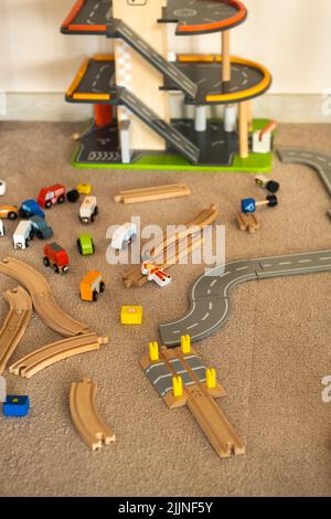 A scattered wooden road construction kit on the floor. Child's play ...