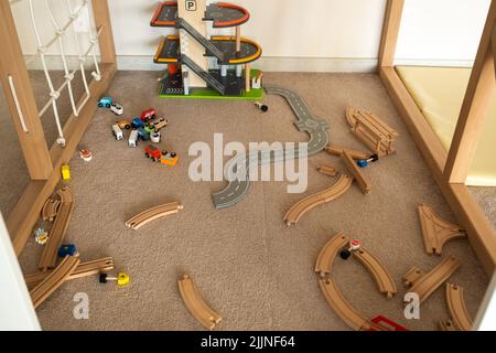 A scattered wooden road construction kit on the floor. Child's play ...