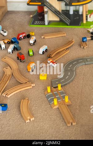 A scattered wooden road construction kit on the floor. Child's play ...