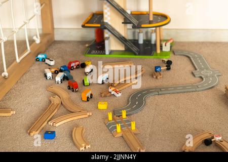 A scattered wooden road construction kit on the floor. Child's play ...