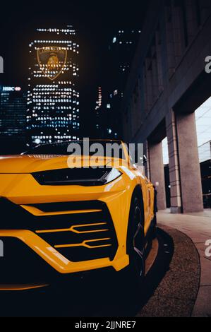 a vertical of Yellow Lamborghini Urus front view with headlights on ...