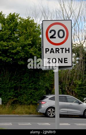 Car passing a 20 mph speed limit sign painted on a road, Nottingham ...