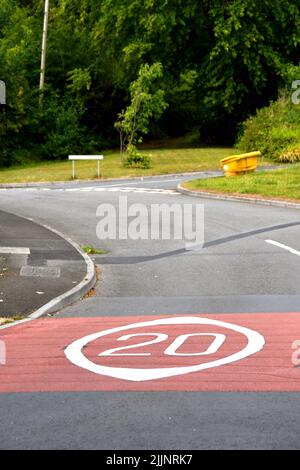 Road markings showing a 20 mph speed limit at the approach to a ...