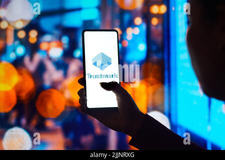 In this photo illustration, the Trustmark logo is displayed on a ...