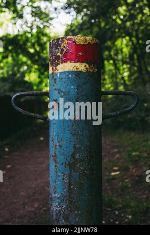 Vertical shot of a red metal pole in front of futuristic industrial ...