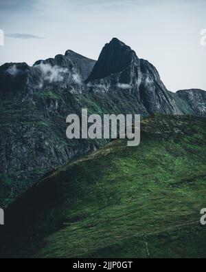 A beautiful shot of a gray cloudy sky over a wooden pier in a rocky ...
