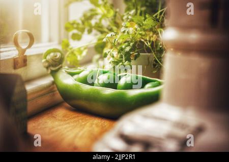 A closeup shot of fresh green peas and cut carrots Stock Photo - Alamy