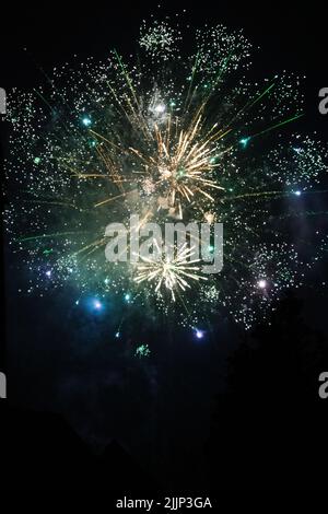 A vertical shot of fireworks at night Stock Photo - Alamy