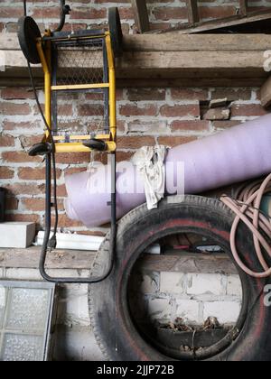 An old wheel and other constructing equipments in a messy area Stock ...