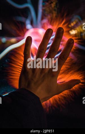 Hand touching a plasma ball. A Plasma ball lamp energy, hand touching ...