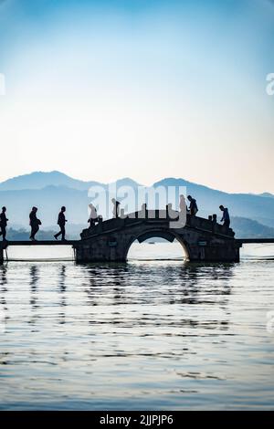 Vertical shot of a male walking on the sidewalk in the city Stock Photo ...