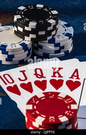 A closeup shot of stacks of poker chips with money and cards Stock ...