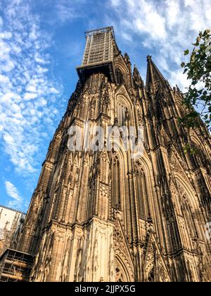 A low angle shot of the Cologne Cathedral in Germany against the blue ...