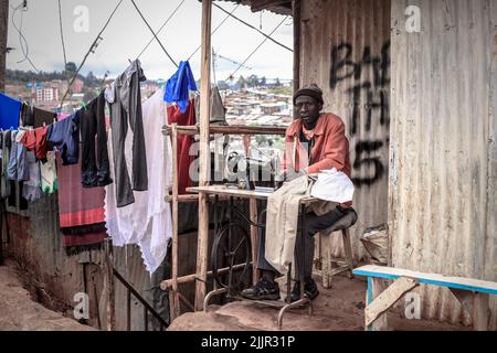 A tailor repairing clothes in Kibera Slum, Nairobi. Life inside Kibera ...