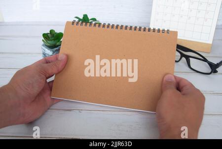 Hand holding brown notepad with motivational quotes text about time ...