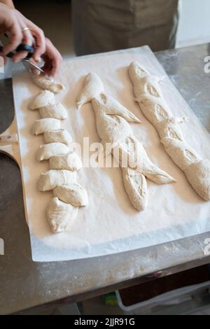 The process of making traditional French baguettes in a craft bakery ...