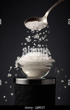 Sea salt is poured into a small glass bowl Stock Photo - Alamy