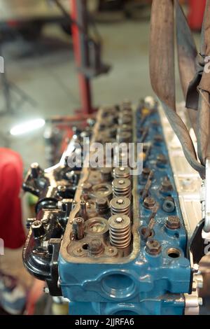 A vertical closeup shot of a mechanic mounting the car engine Stock ...