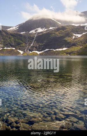 Snow covered mountains with rocky patches in the arctic in Svalbard ...