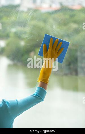 Female hand with rag washing window in room, closeup Stock Photo - Alamy
