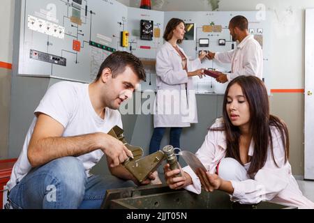 Friends inspecting box with facilities in quest room Stock Photo - Alamy