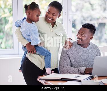 A woman and her young daughter are huddled together looking over their ...