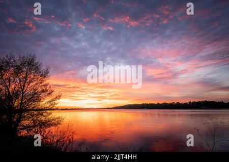 A beautiful shot of a colorful sunset over a river in the evening Stock ...