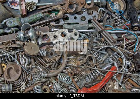 A heap of various old hand tools, springs, and screws in a junk shop in ...