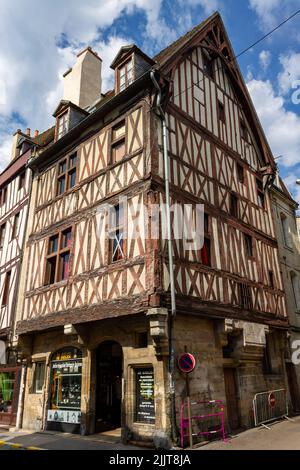 A low-angle shot of the half-timbered facade of a building against the ...