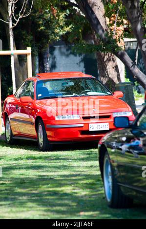 A vertical shot of old red Opel Calibra on display at a car show Stock ...