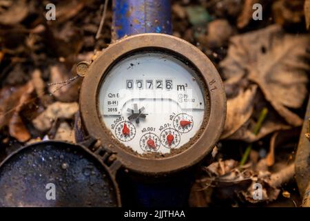 Water meter close-up. Measurement of water flow with direction arrow ...