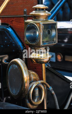 Vertical shot of an old vintage car parked in front of an old house ...