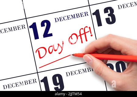 12th day of December. Hand writing text GOAL PLAN ACTION on calendar ...