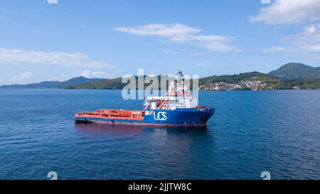 Industrial offshore anchor handling supply vessel sailing in open sea ...