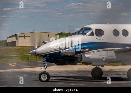 A closeup shot of a King Air plane getting ready to fly at the airport ...