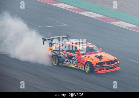 Orange Bmw E36 drift at the Navarra circuit Stock Photo - Alamy