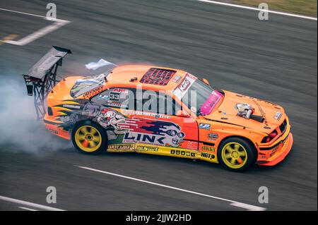 Orange Bmw E36 drift at the Navarra circuit Stock Photo - Alamy