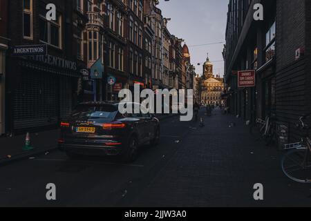 An early morning sight in Amsterdam with cars and bicycles parked on ...